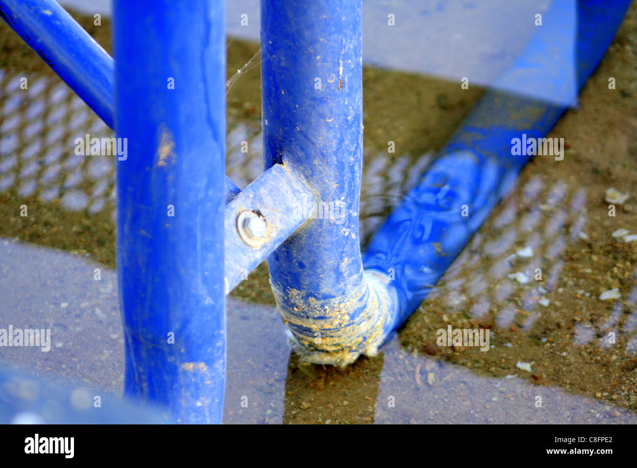 Metal bench in the water Stock Photo - Alamy