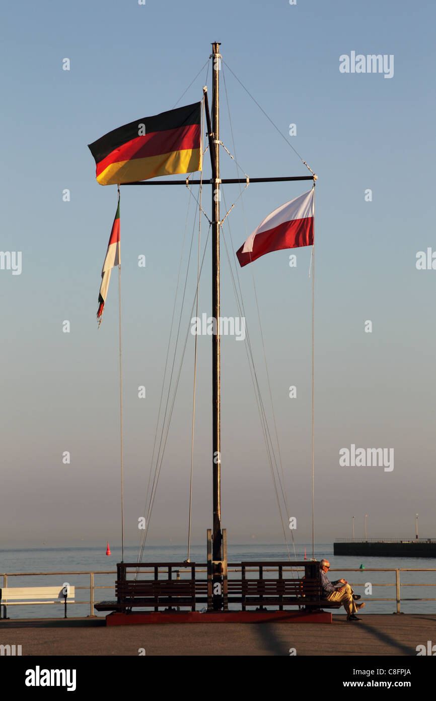 Flagpole in the harbour of Helgoland with the flags of Germany and ...