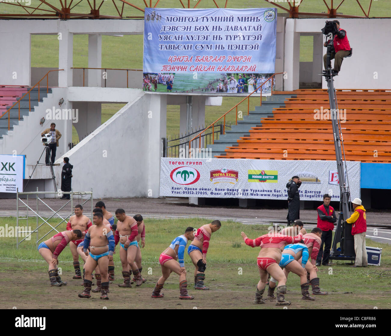 Wrestlers prepare for combat inside the Erdenet Naadam Stadium at the ...