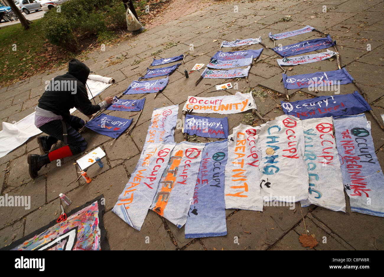 The young girl is drawing a signs for "occupy Toronto" demonstration in ...