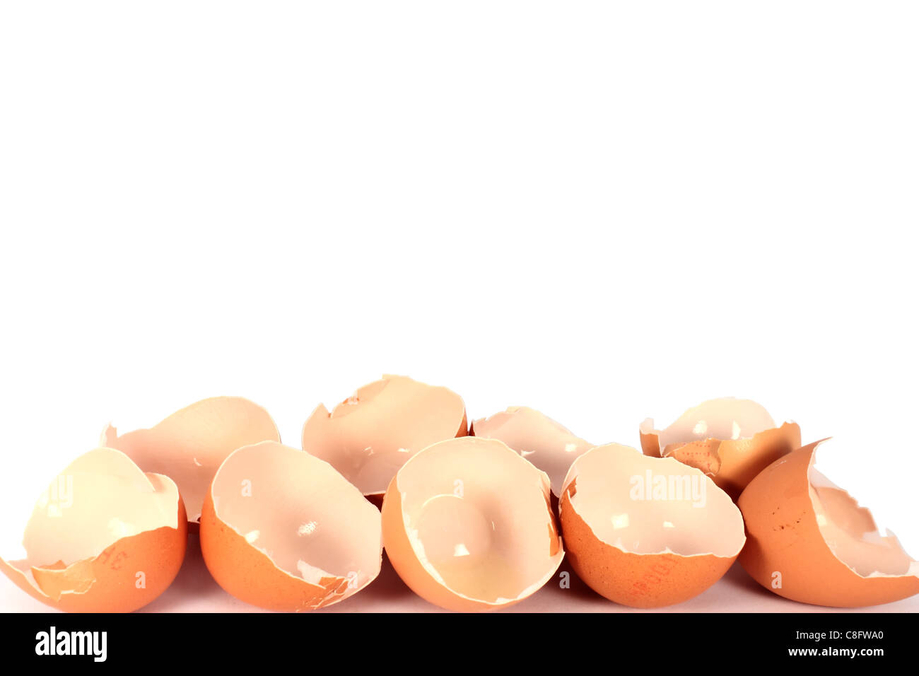 Broken egg shells on white background Stock Photo - Alamy