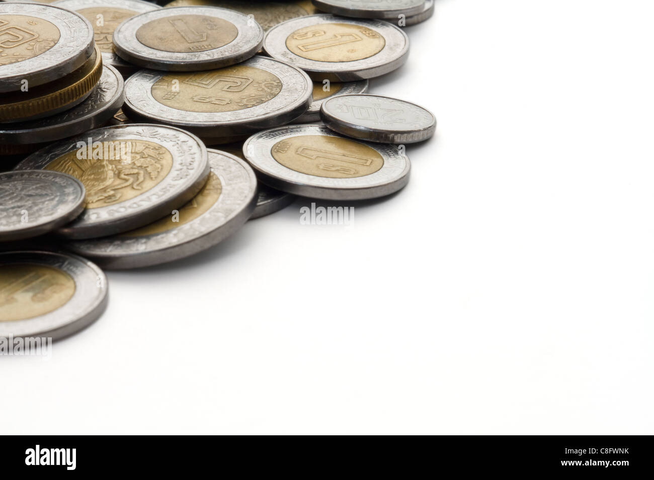 The edge of a pile of current, modern, Mexican Peso coins. Copy space ...