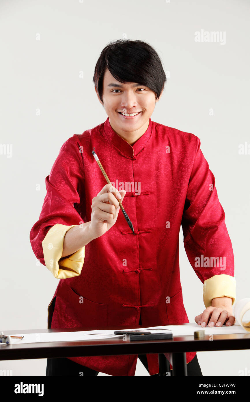 Man about to write a chinese character on the paper Stock Photo - Alamy