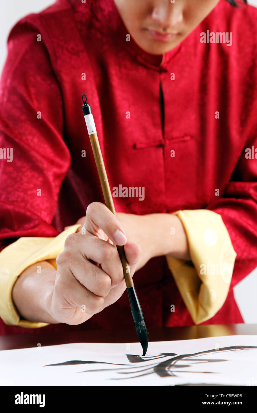 Man writing a chinese character on a blank piece of paper Stock Photo ...