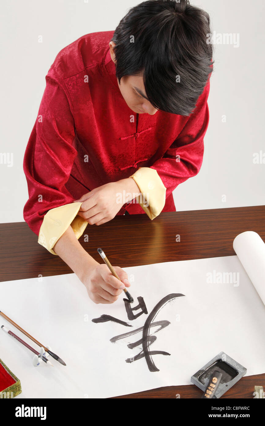 Man writing a chinese character on a blank piece of paper Stock Photo ...