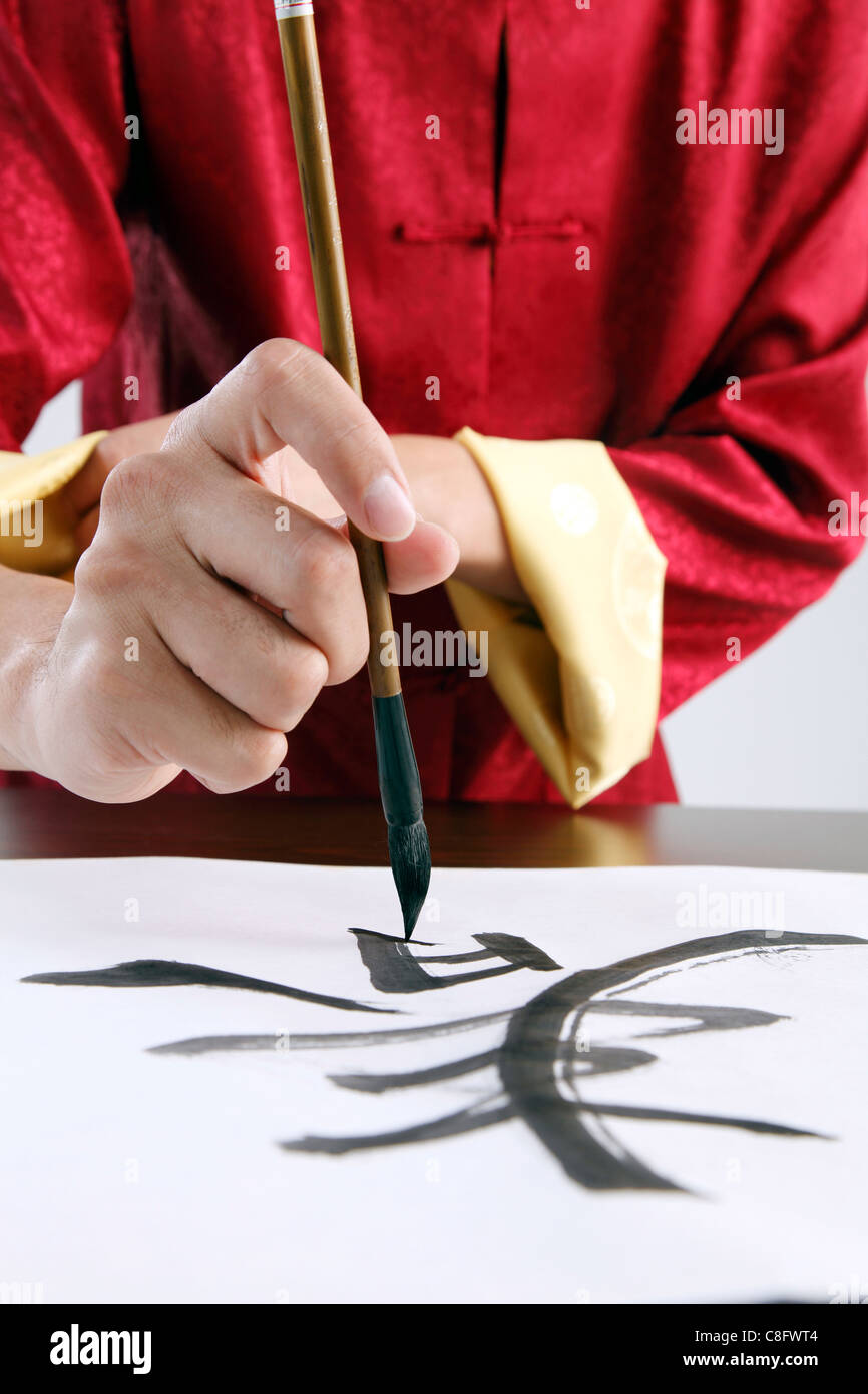 Man writing a chinese character on a blank piece of paper Stock Photo ...