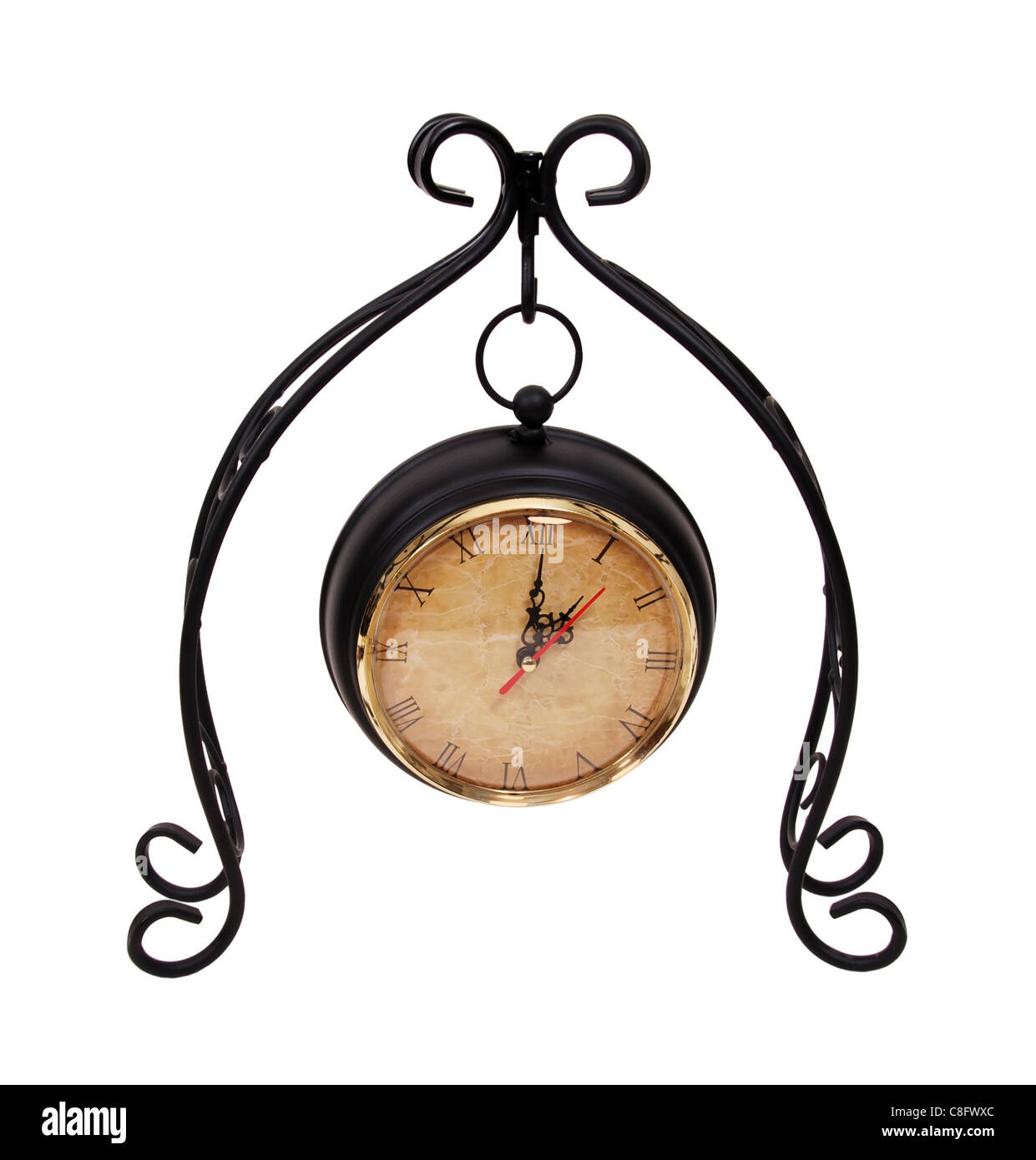 Formal clock hanging from a scrolled metal work to measure time passing ...