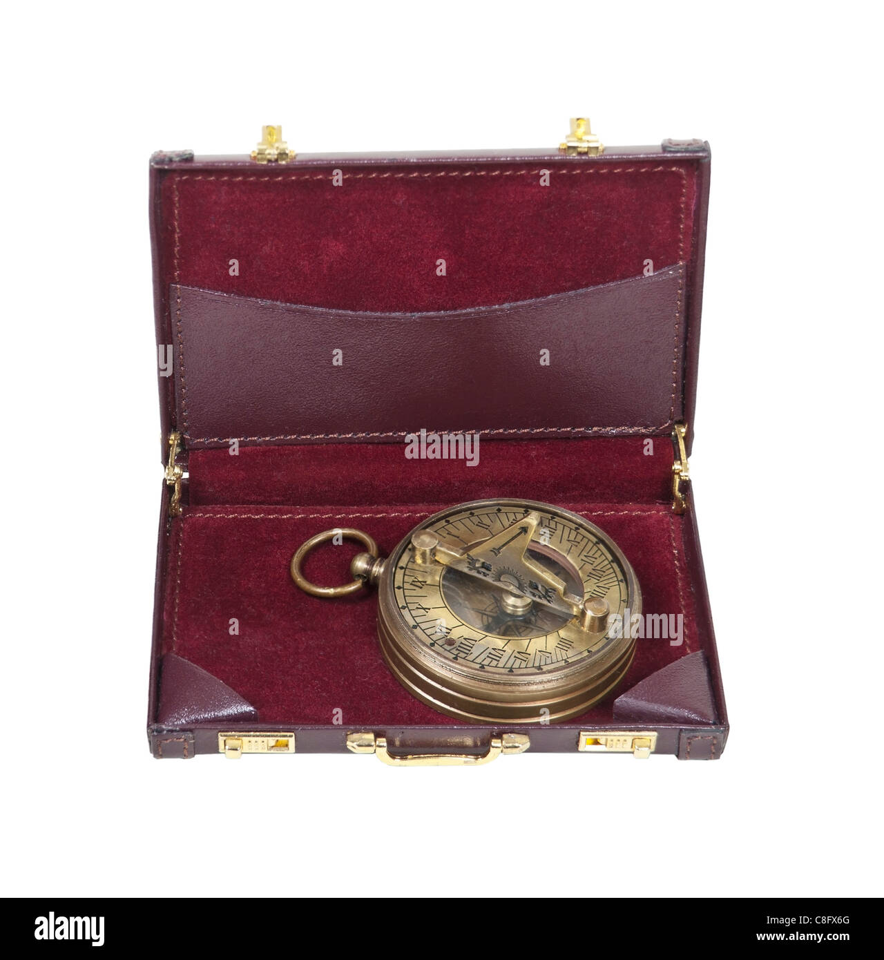 Brass sundial used to tell time as referenced by the sun in a leather ...