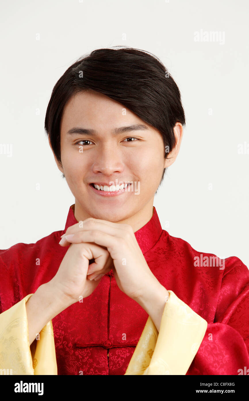 man in Chinese traditional clothes greeting other people chinese new ...