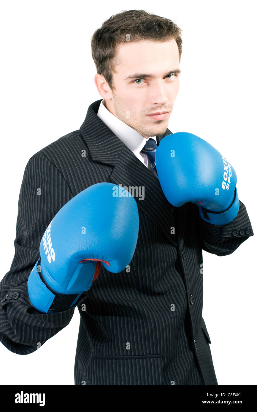 Handsome young man in suit and blue gloves boxing in office, made in ...