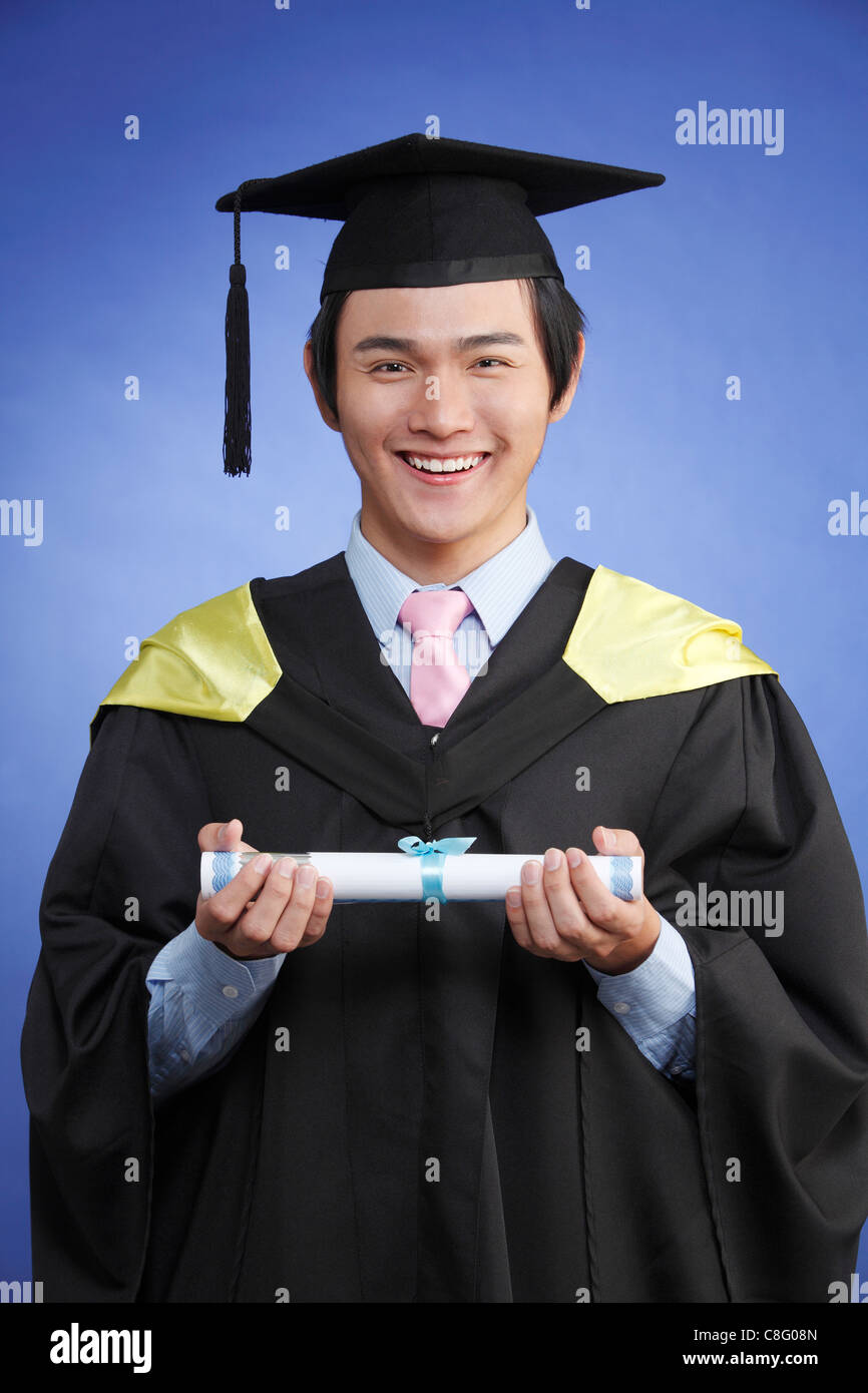 man holding diploma with two hands Stock Photo - Alamy