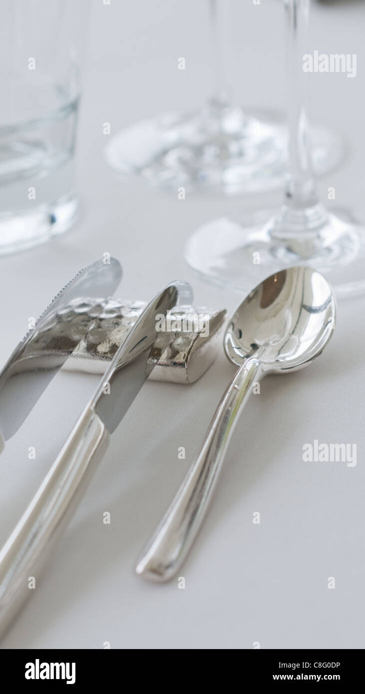 Two knives and a spoon on a restaurant table. Shallow depth of field ...