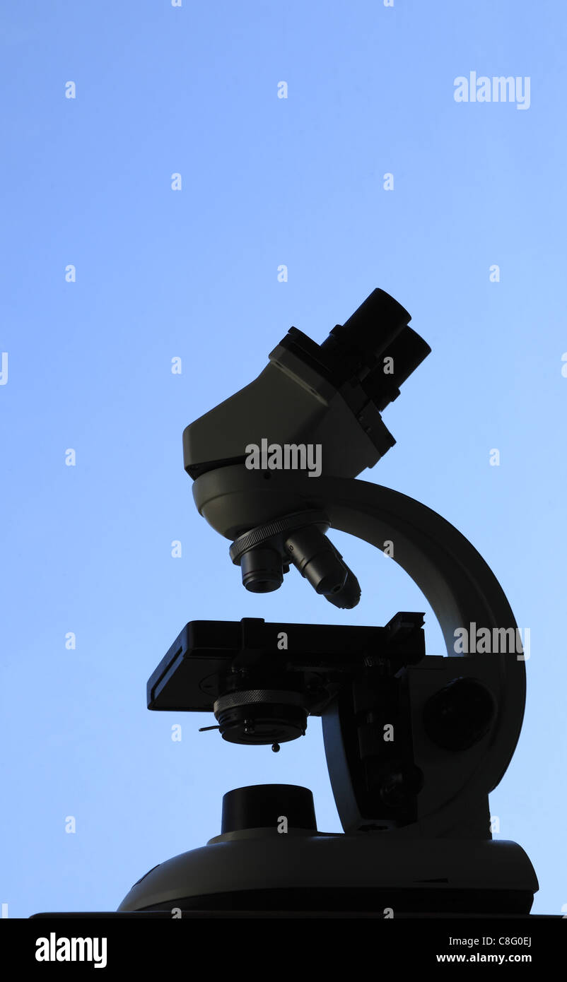 Black silhouette of a microscope against a blue sky Stock Photo - Alamy
