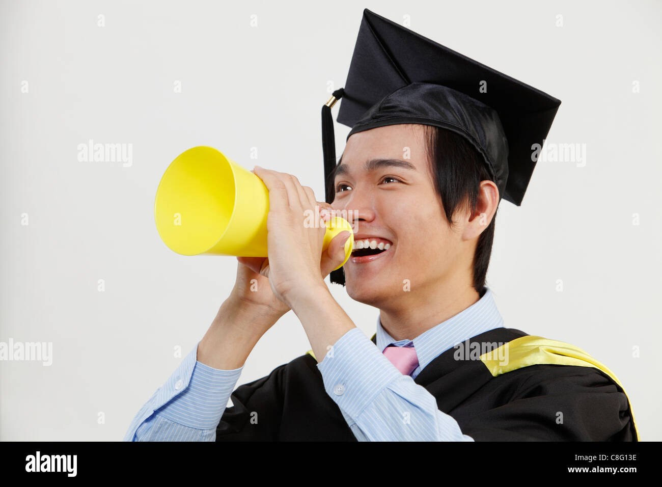 graduated man shouting in the megaphone Stock Photo - Alamy