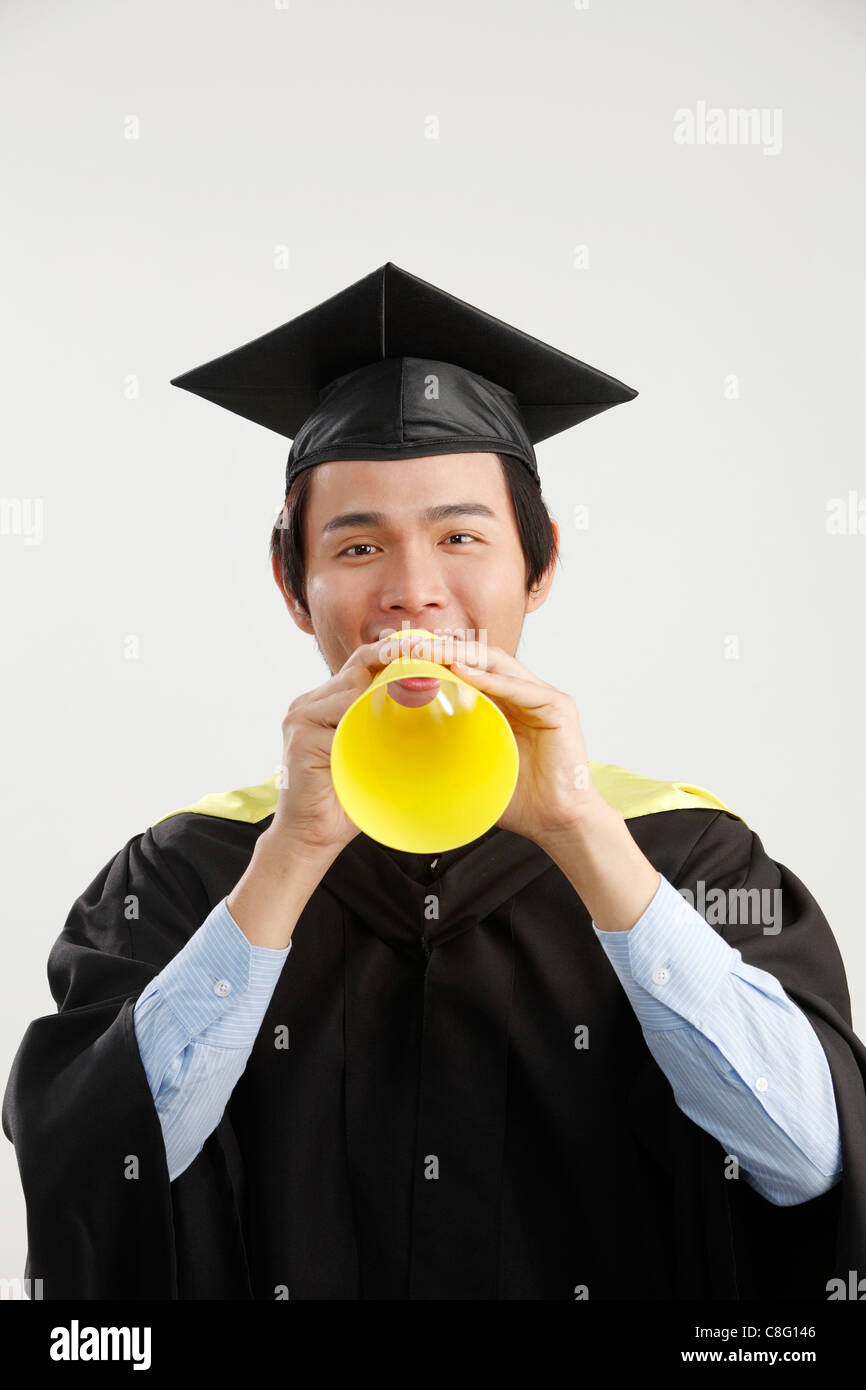 graduated man shouting in the megaphone Stock Photo - Alamy