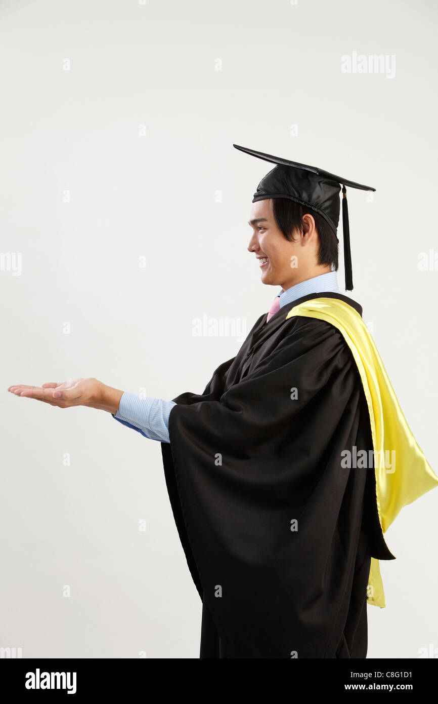 male graduated raising arm asking for help Stock Photo - Alamy
