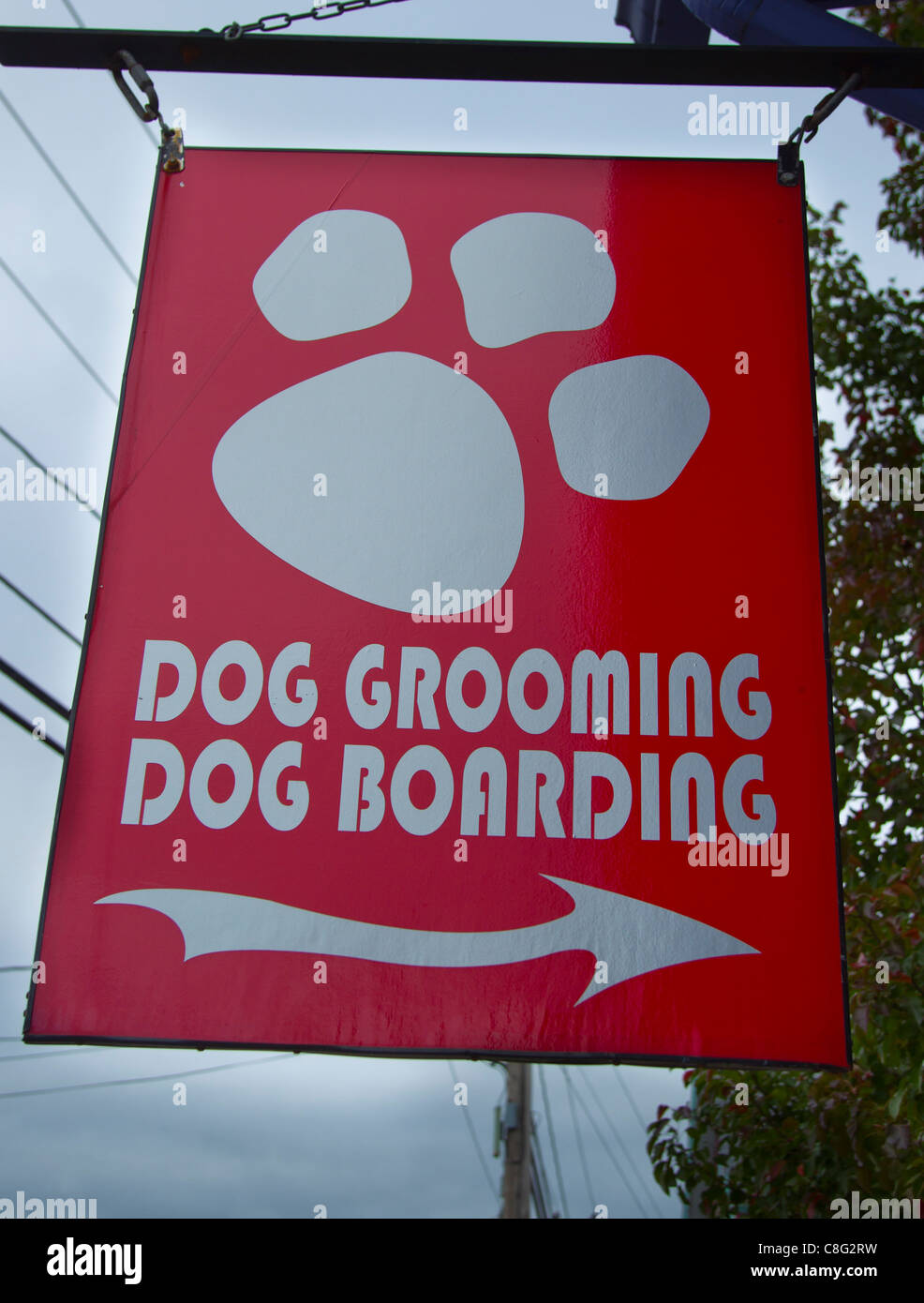 A sign above a dog grooming store Stock Photo - Alamy