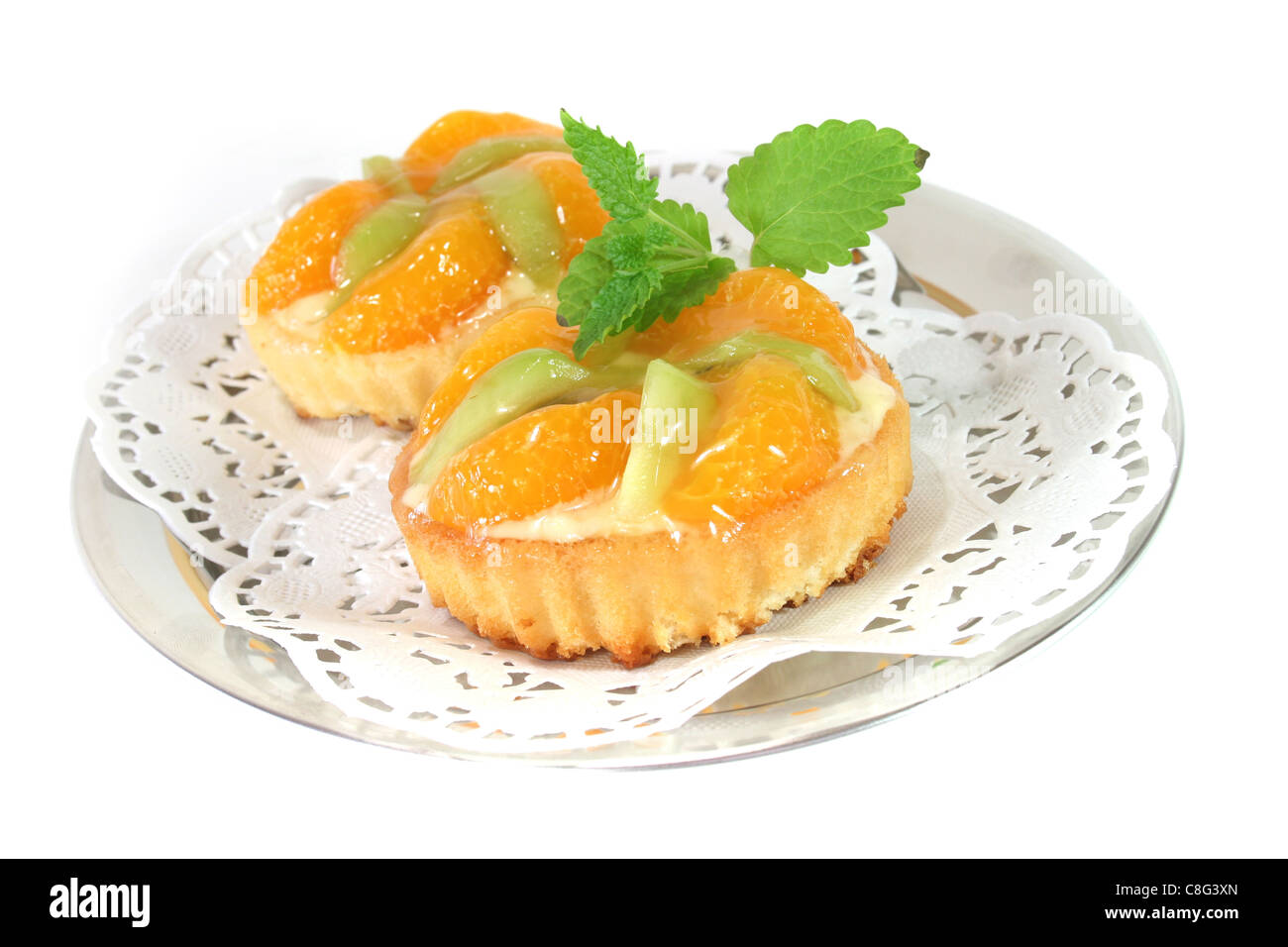 Mandarin tartlet with lemon balm on a silver platter Stock Photo - Alamy