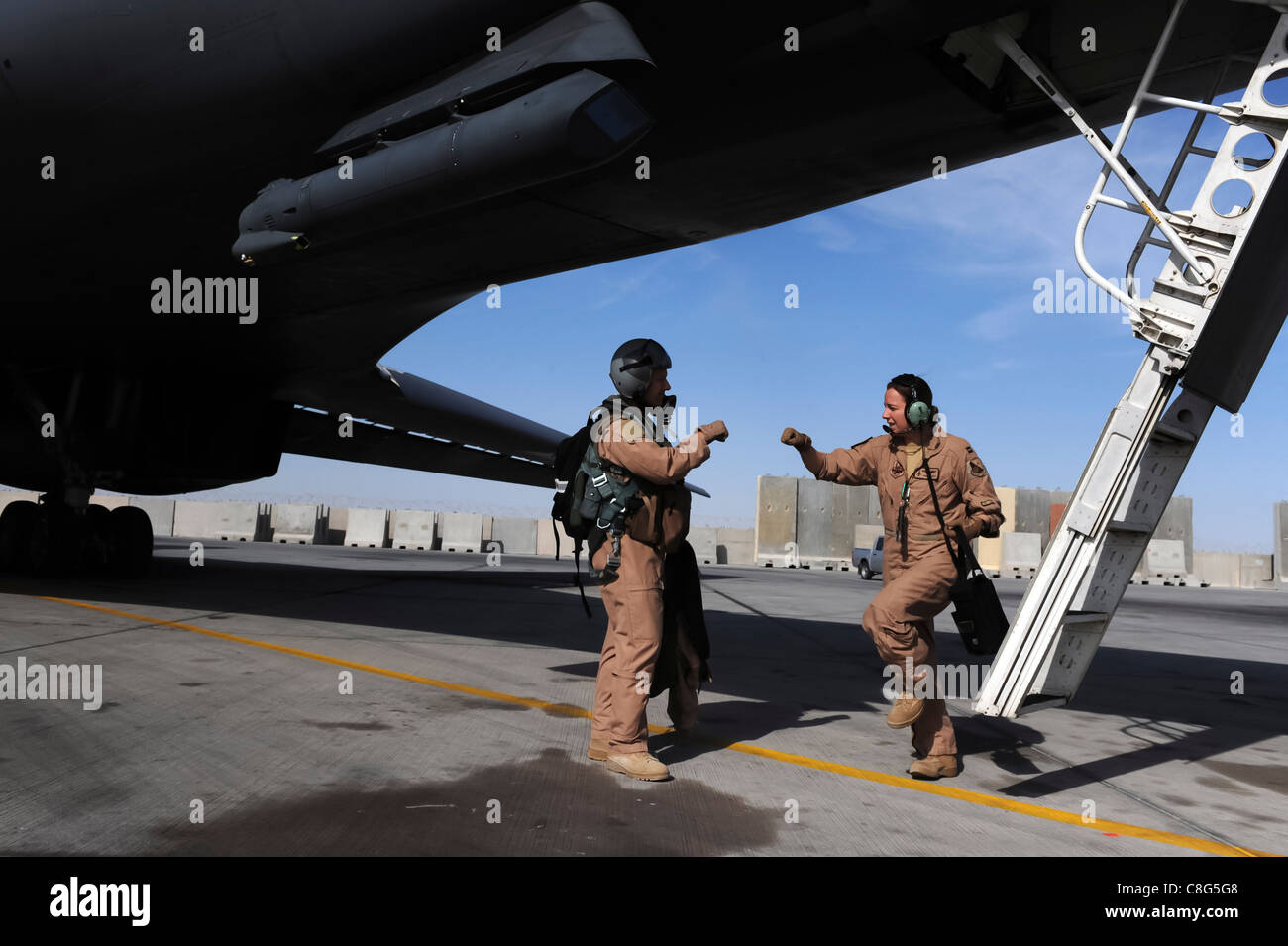 Lt. Col. John Martin and Capt. Tara Hart exchange a good-luck gesture ...