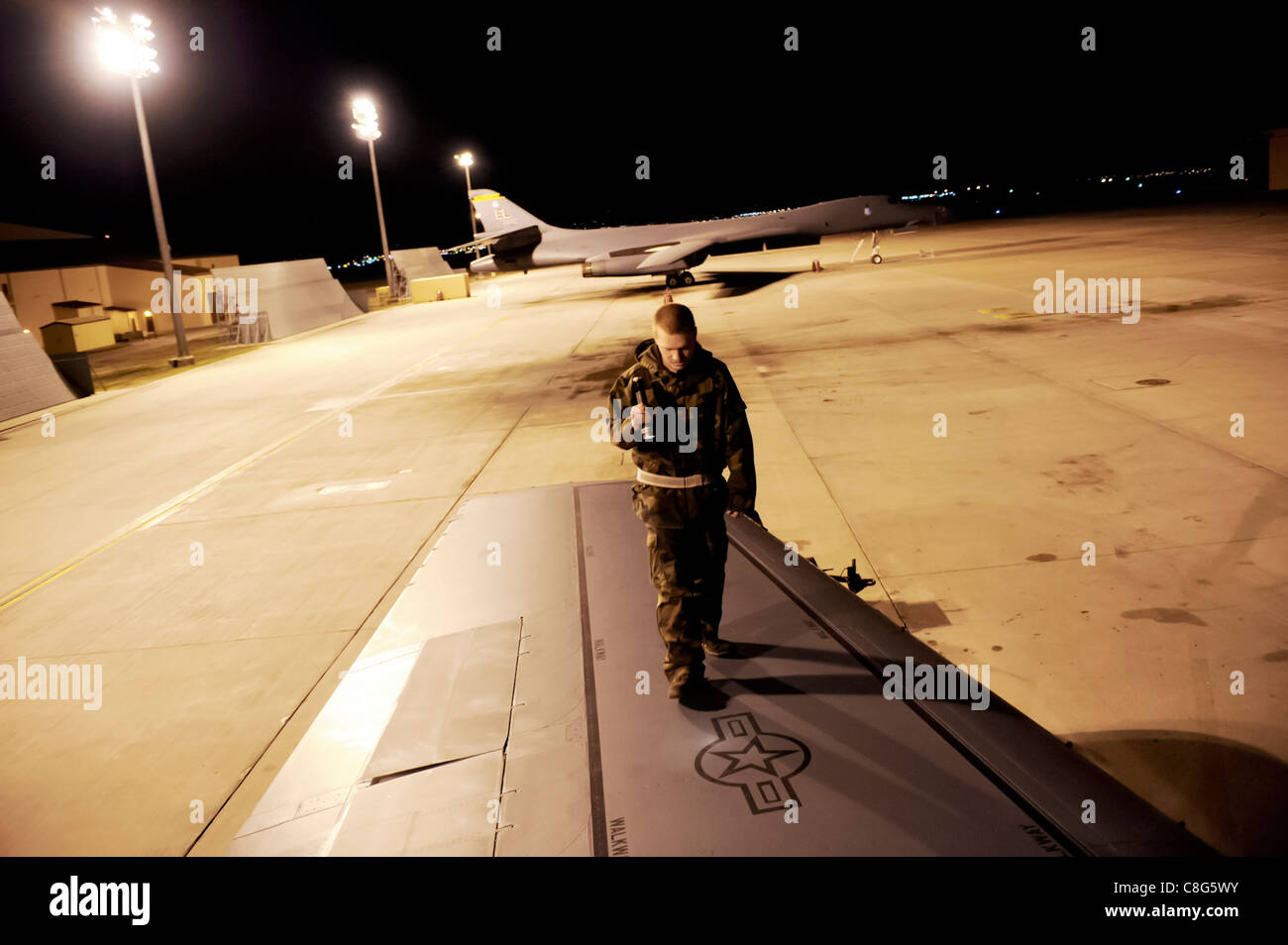 Senior Airman Scott Foust takes a closer look at a B-1B Lancer wing ...