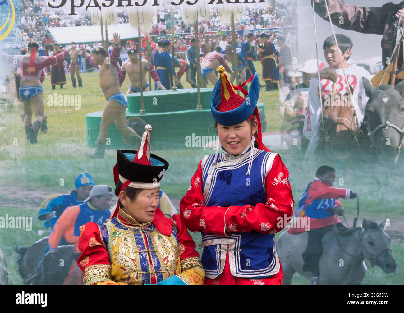 Two locals are photographed in front of a tableau of the events of a ...