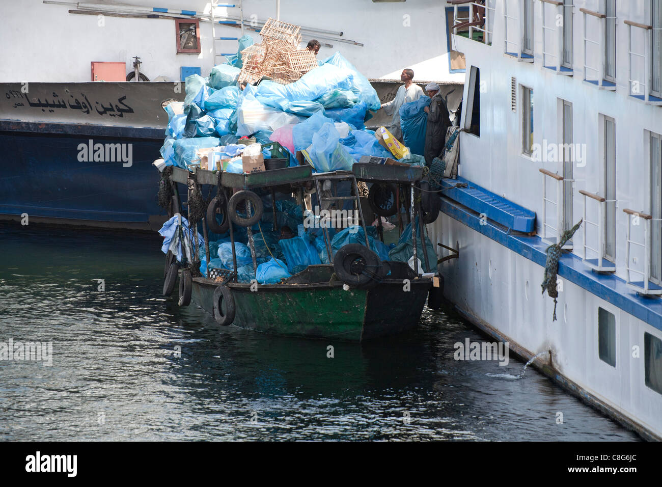 Garbage collection boat blue rubbish sacks nile cruise boat hi-res ...