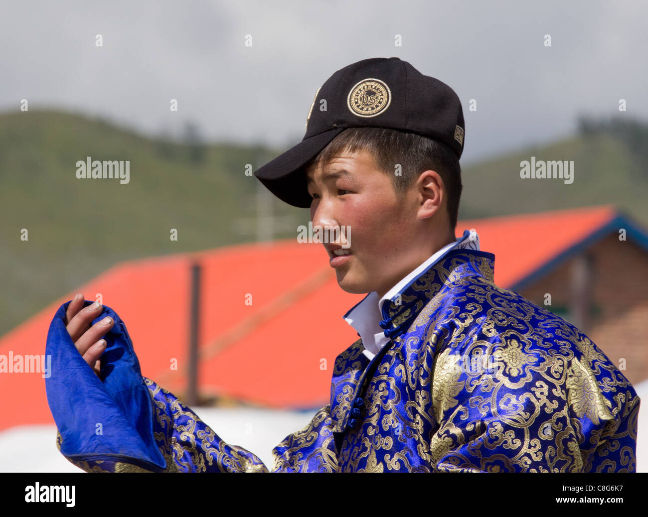 At the Tsetserleg Naadam a Mongolian youth rides to the stadium wearing ...
