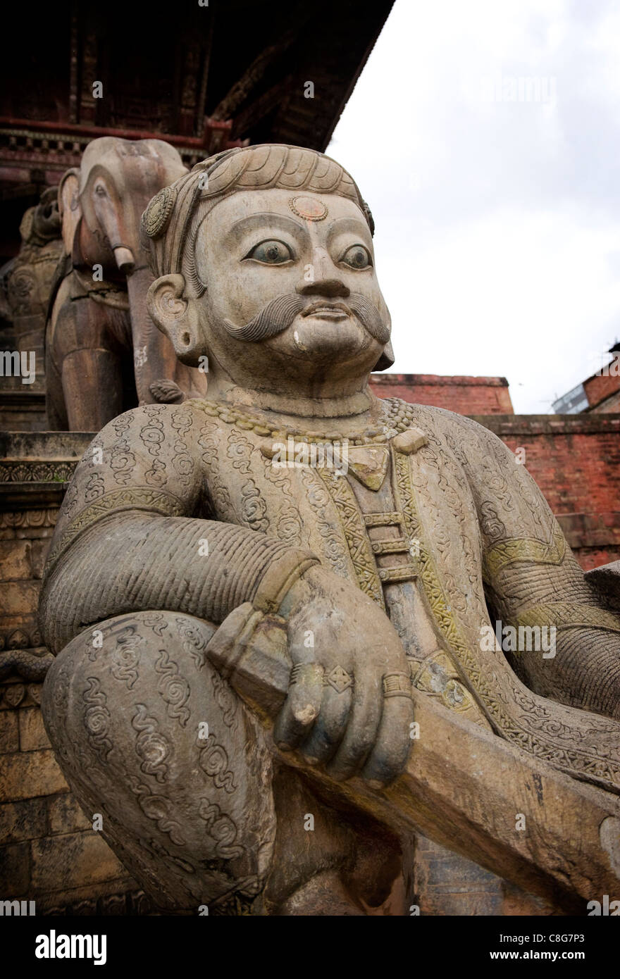 The stone figure of Phattu guards the bottom plinth of the Nyataploa ...