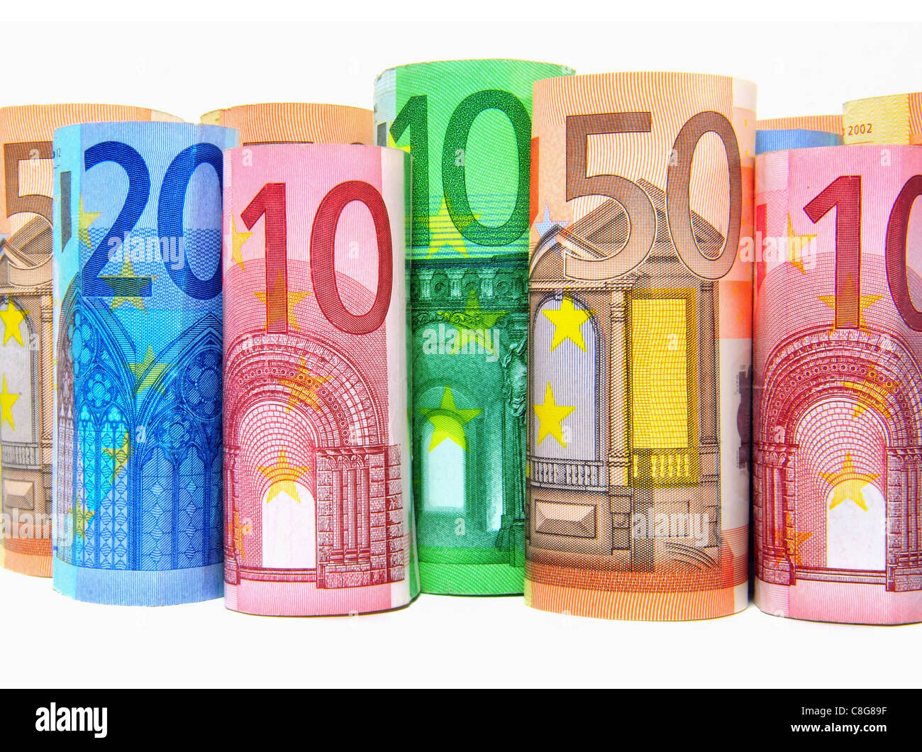 Rolled up Euro banknotes on white background Stock Photo - Alamy