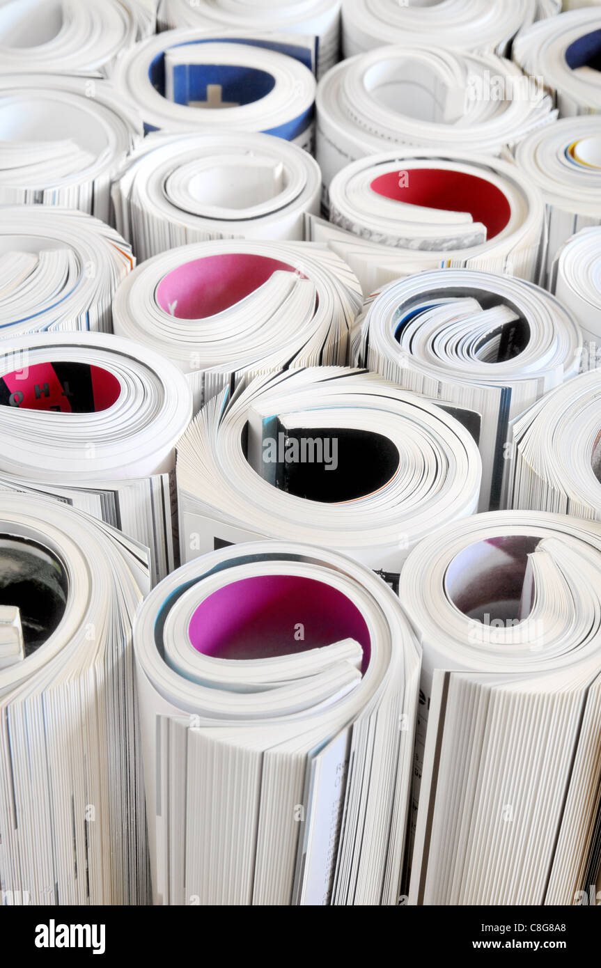 Rolled up magazine on white background Stock Photo - Alamy