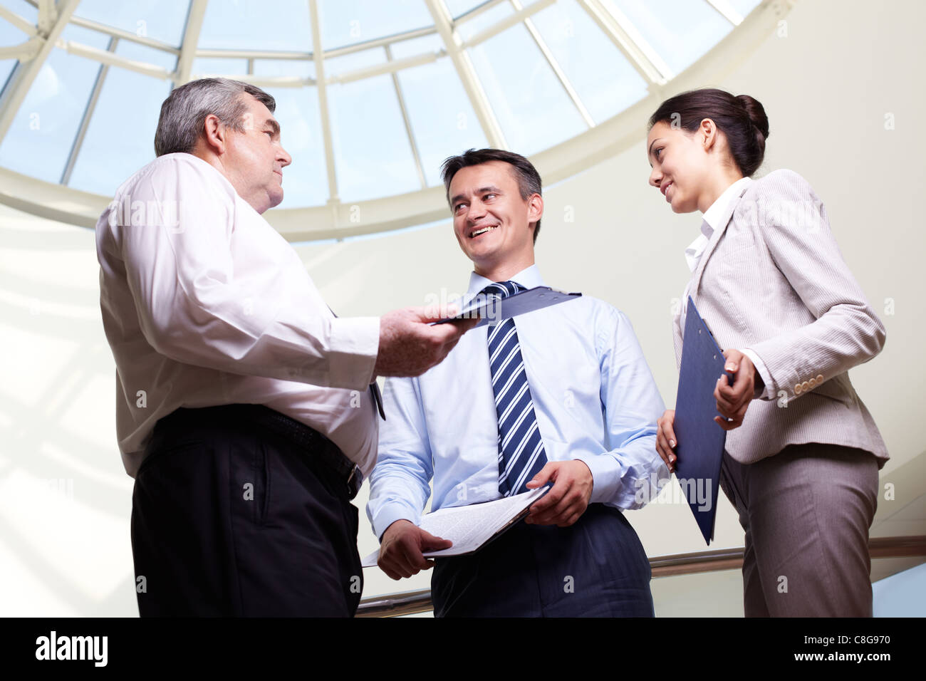 Portrait of three partners discussing ideas at meeting Stock Photo - Alamy