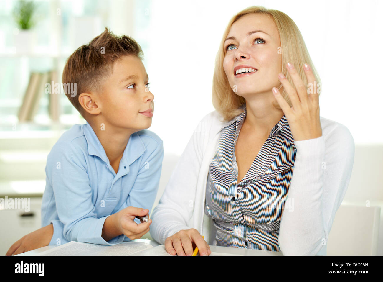 Portrait of pretty tutor sharing her idea of plot while discussing book ...