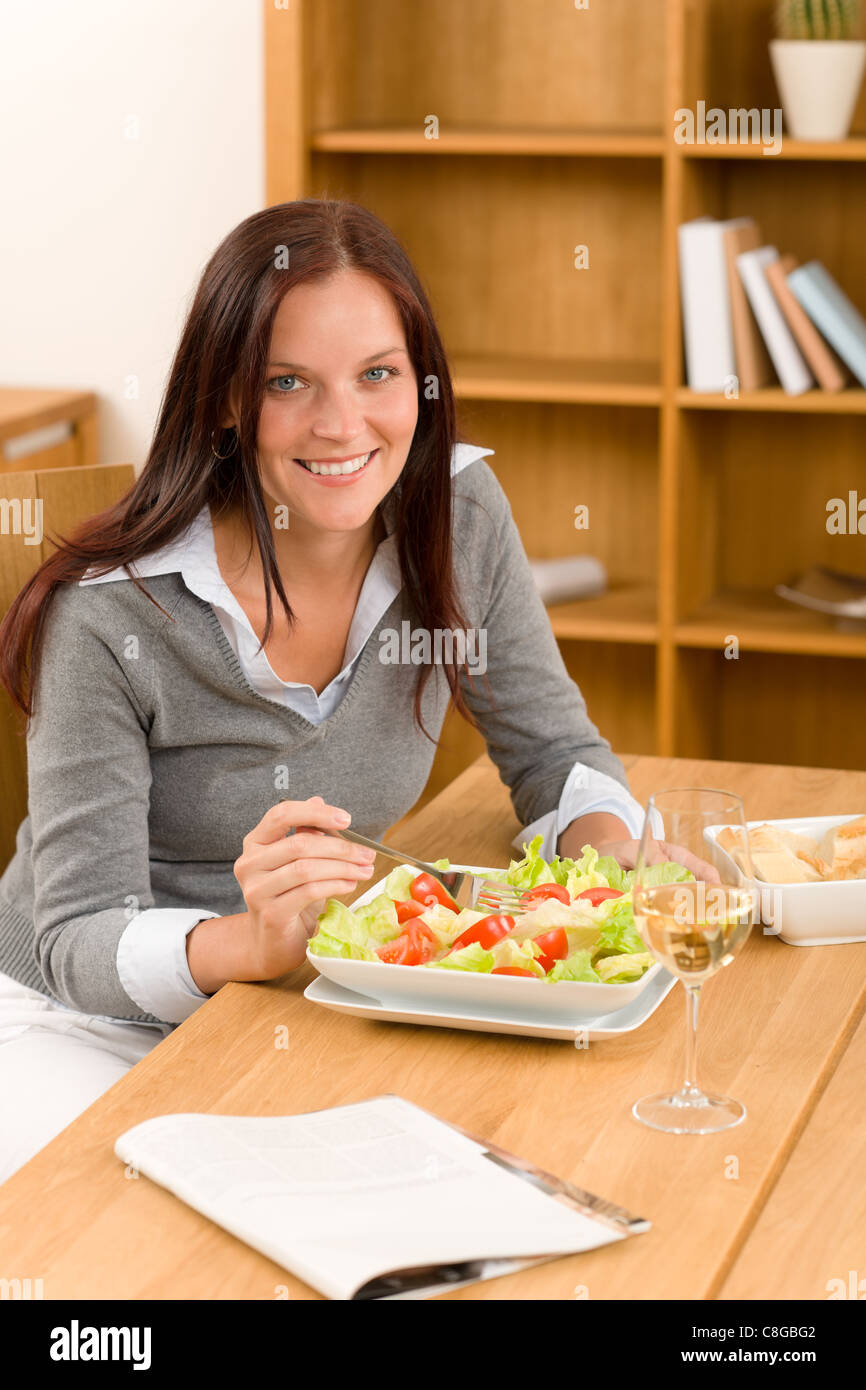 Healthy lunch at home attractive woman read magazine eat salad Stock ...