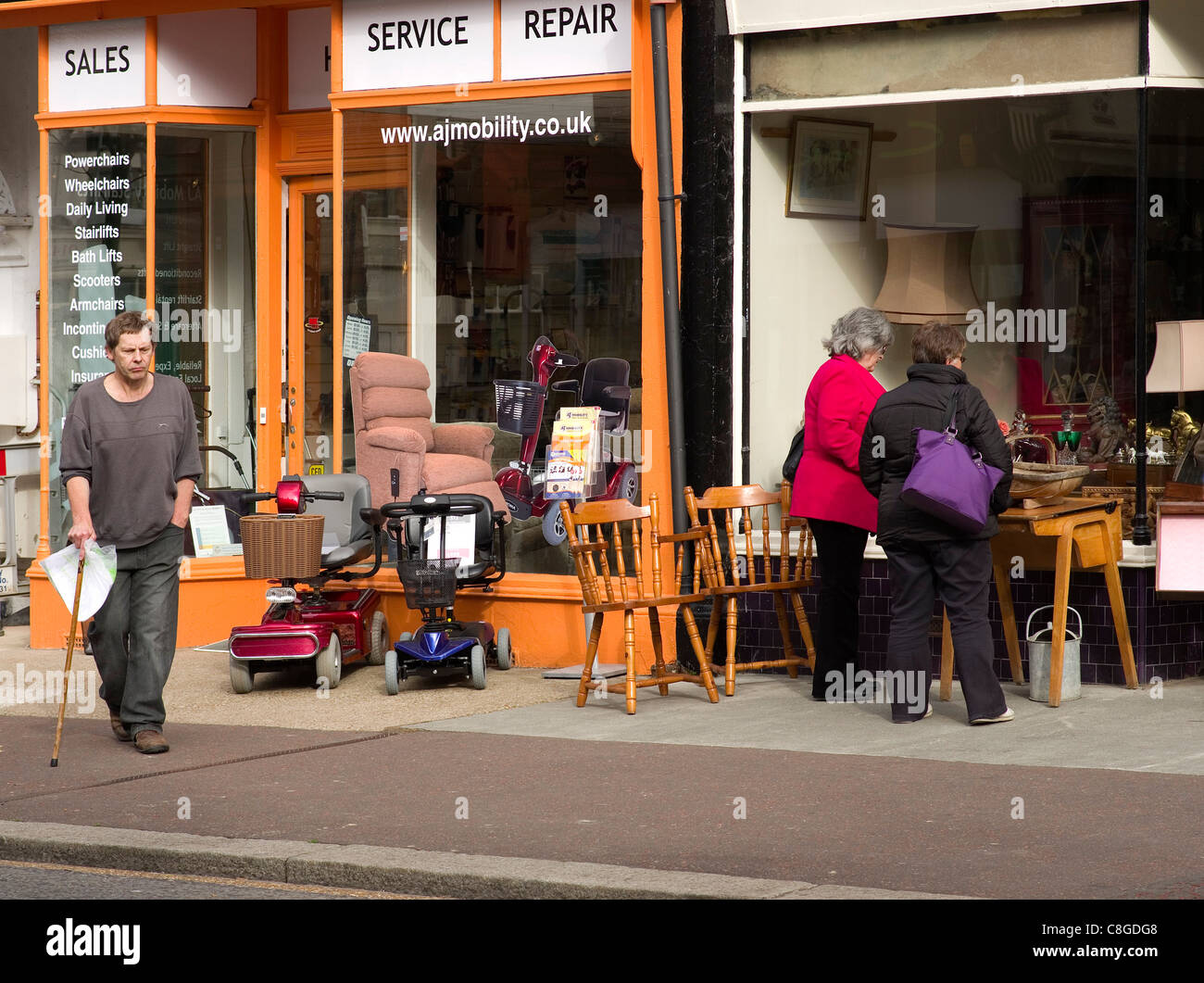 older people outside a small shop selling mobility scooter Stock Photo ...