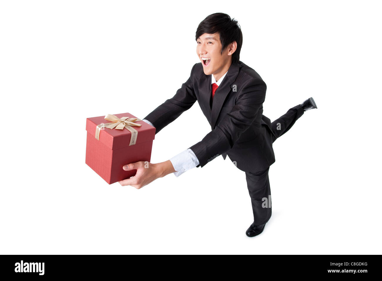 Excited Businessman Holding a Gift Stock Photo - Alamy