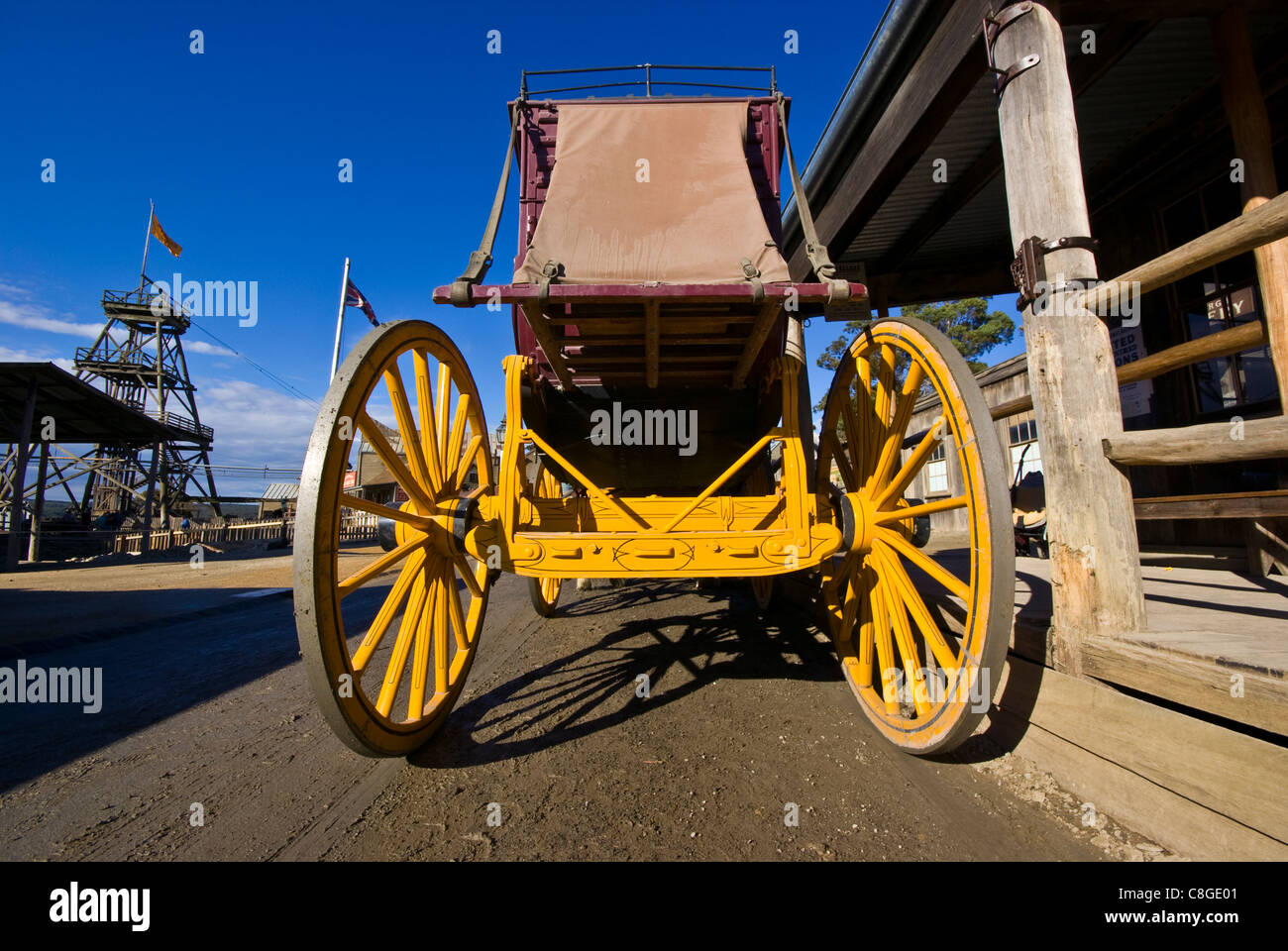 The bright yellow spokes of huge wagon-wheels on a stagecoach Stock ...