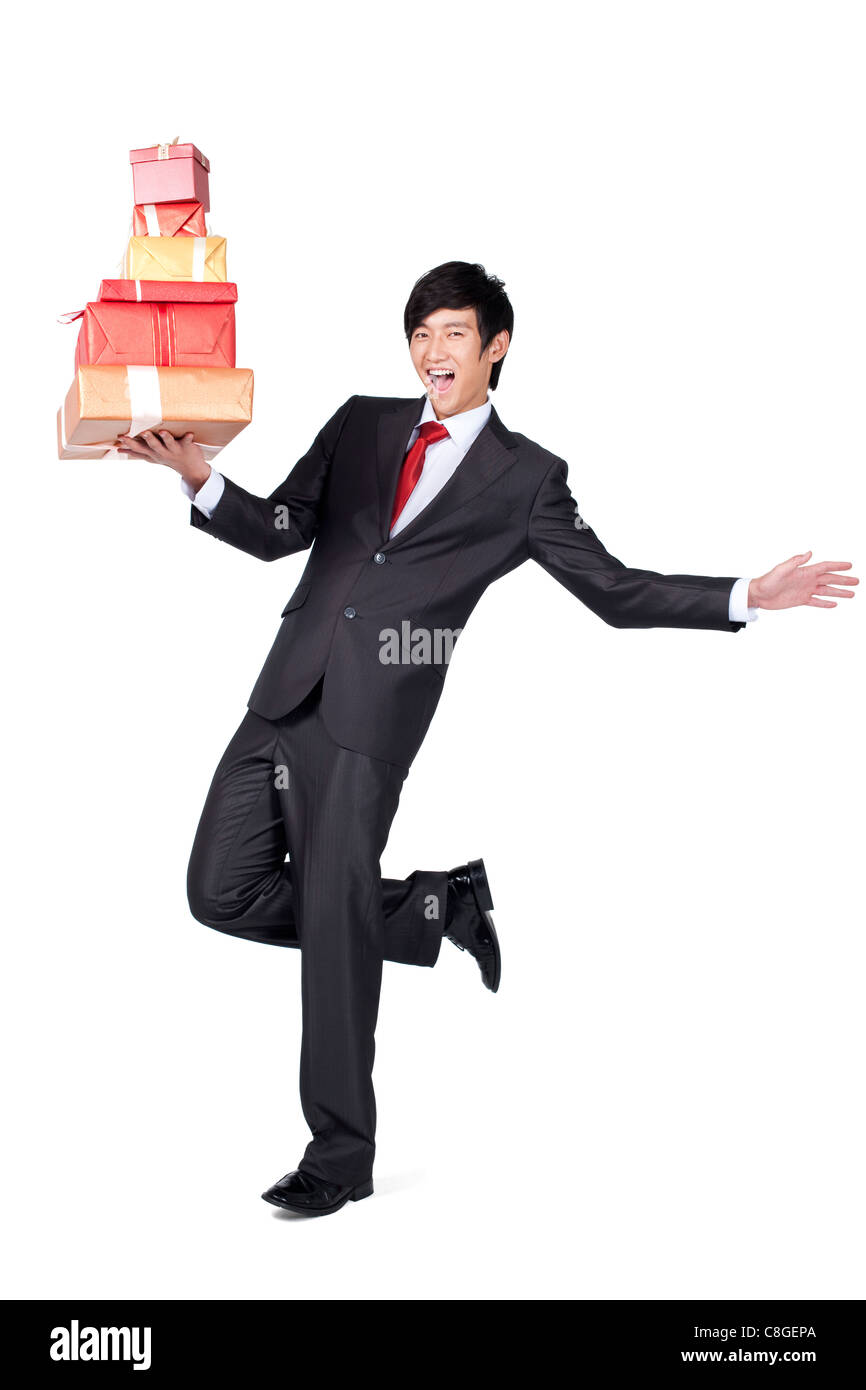 Excited Businessman Holding a Stack of Gifts Stock Photo - Alamy