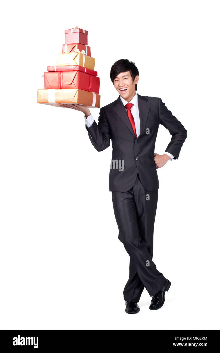 Excited Businessman Holding a Stack of Gifts Stock Photo - Alamy