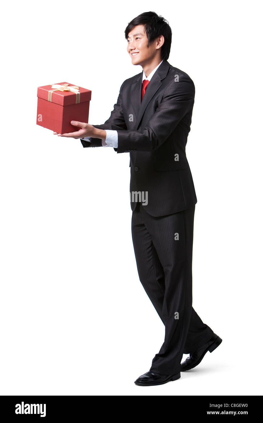 Happy Businessman Holding a Gift Stock Photo - Alamy