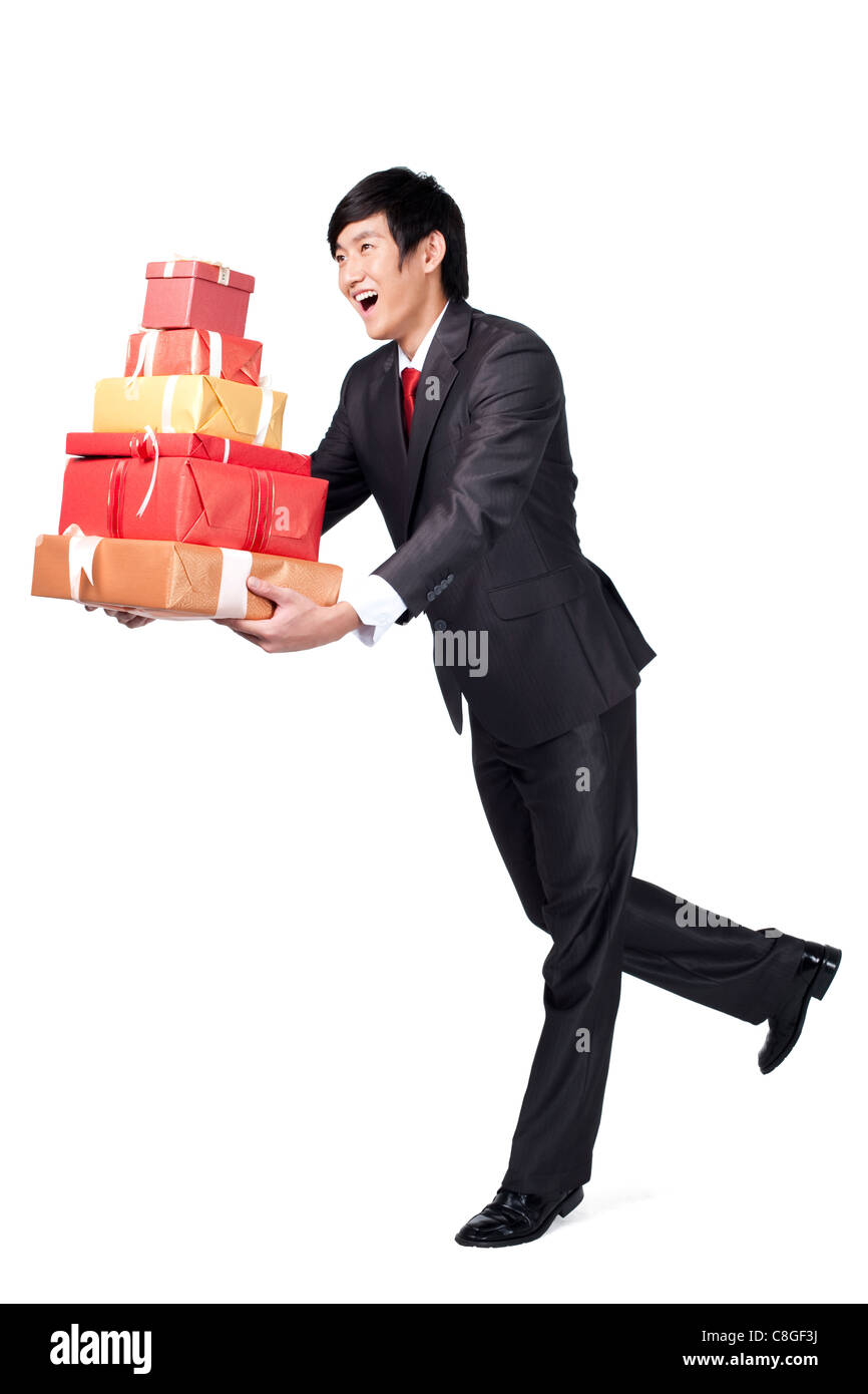 Excited Businessman Holding Gifts Stock Photo - Alamy