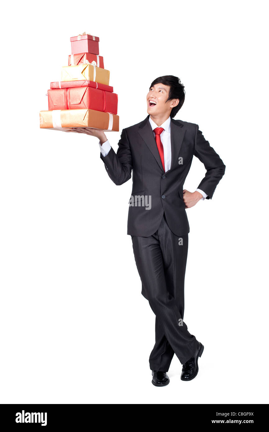 Excited Businessman Holding a Stack of Gifts Stock Photo - Alamy