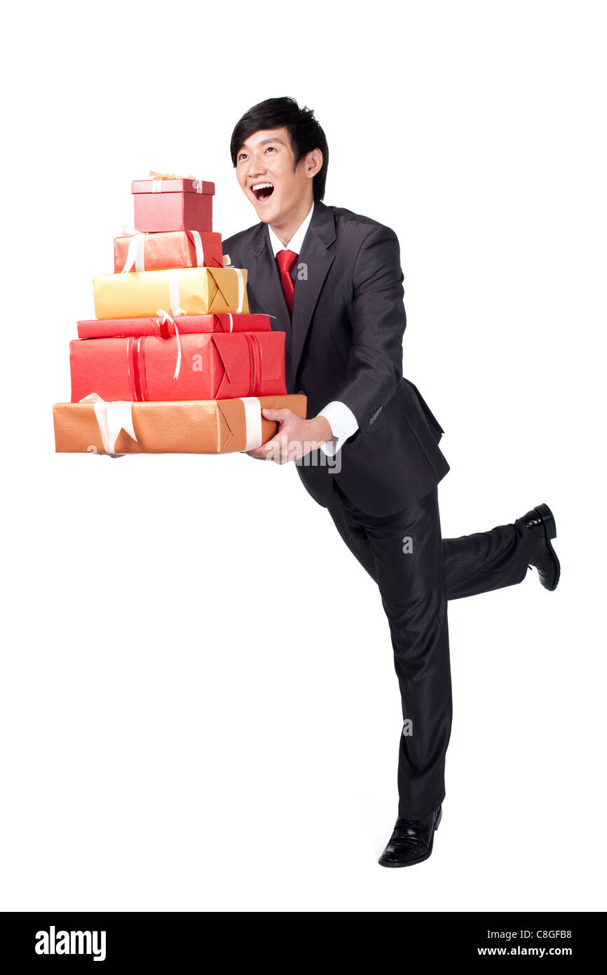 Happy Businessman Holding a Gift Stock Photo - Alamy