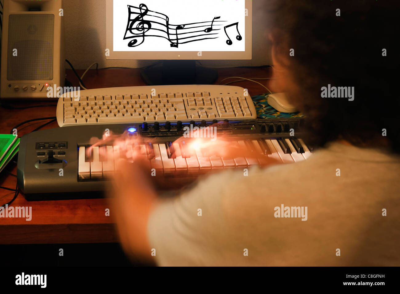 Midi keyboard player working in studio Stock Photo - Alamy