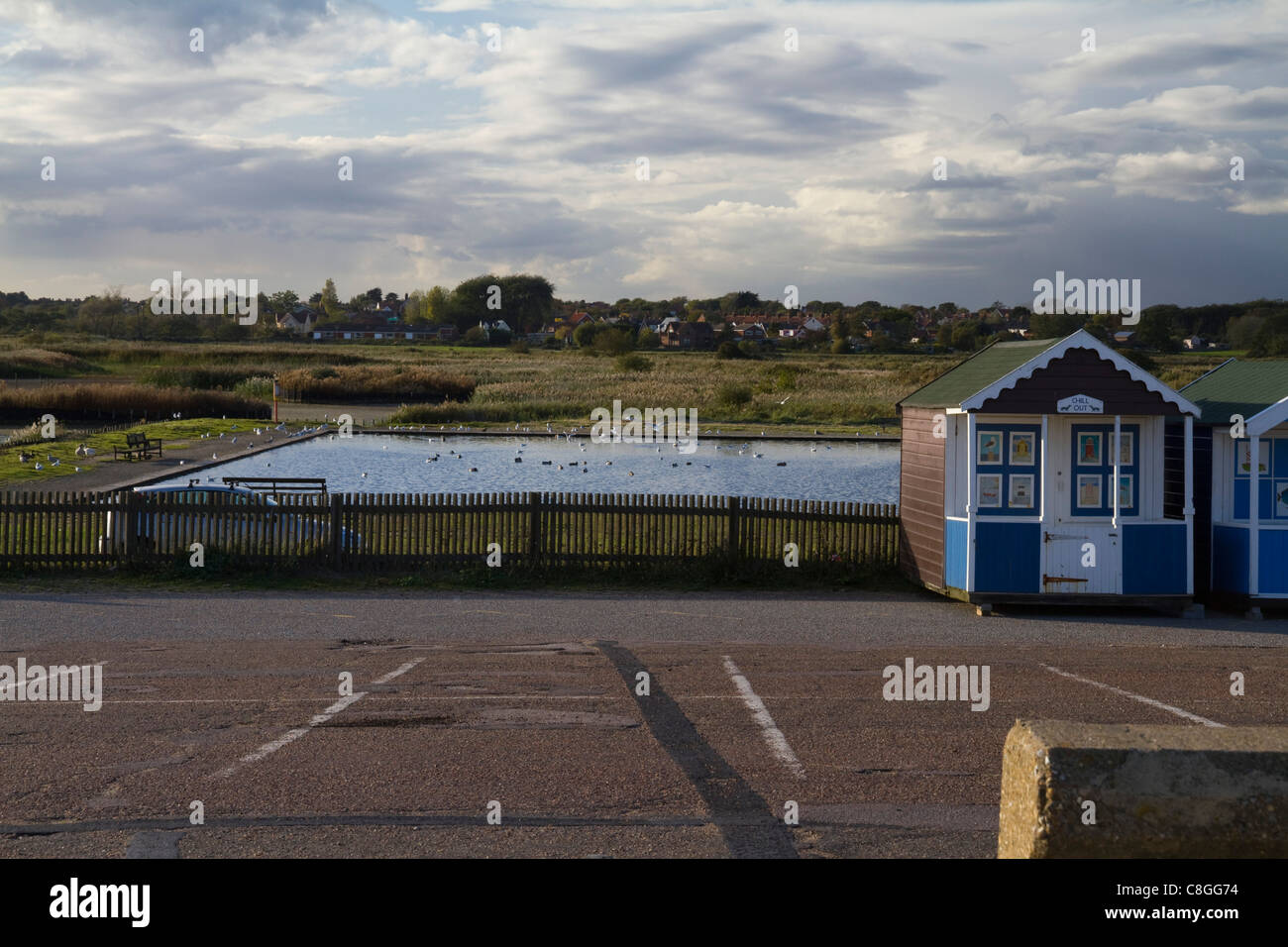 Beach huts stand on the edge a car park rather than the sea at ...