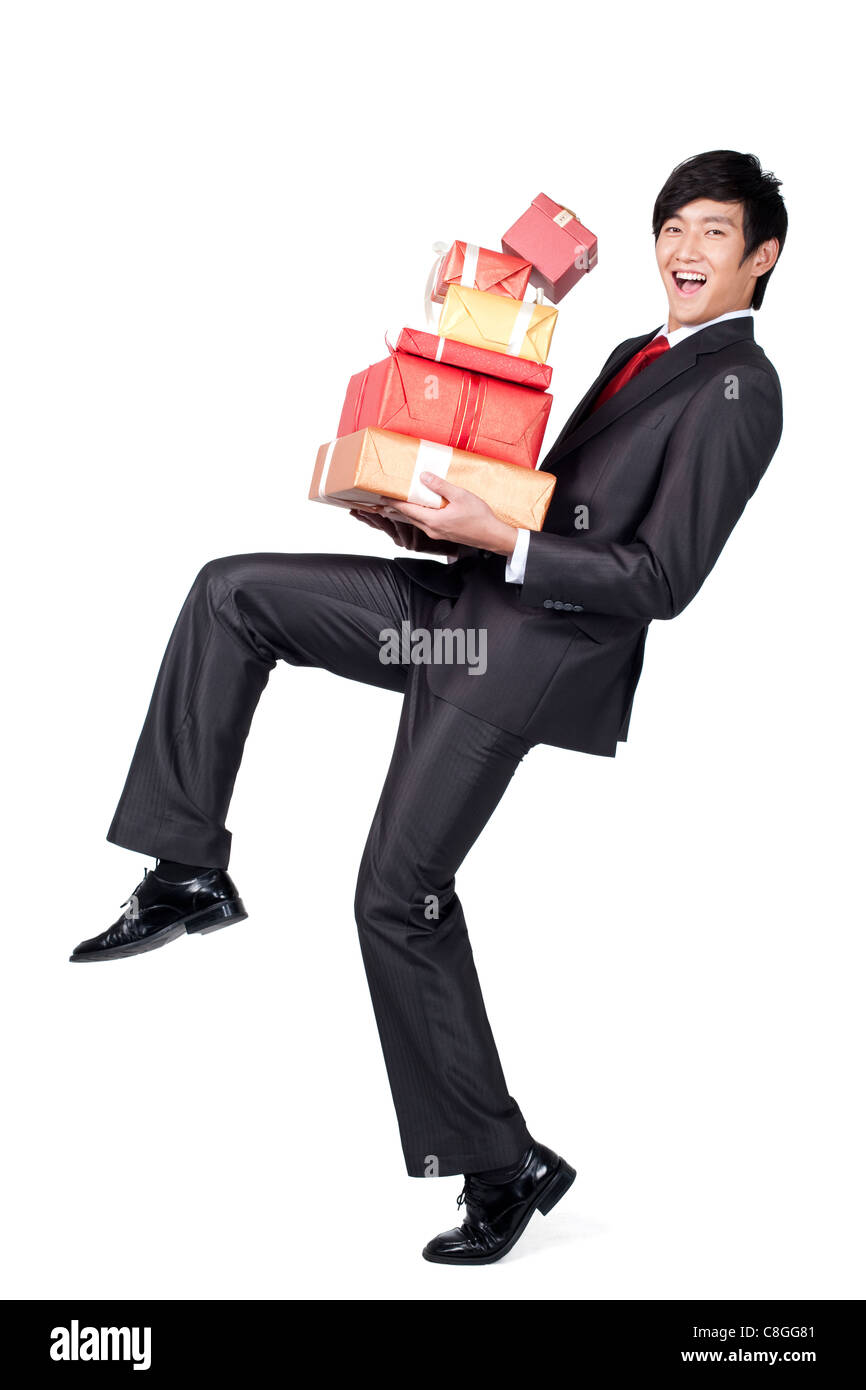 Excited Businessman Holding a Stack of Gifts Stock Photo - Alamy