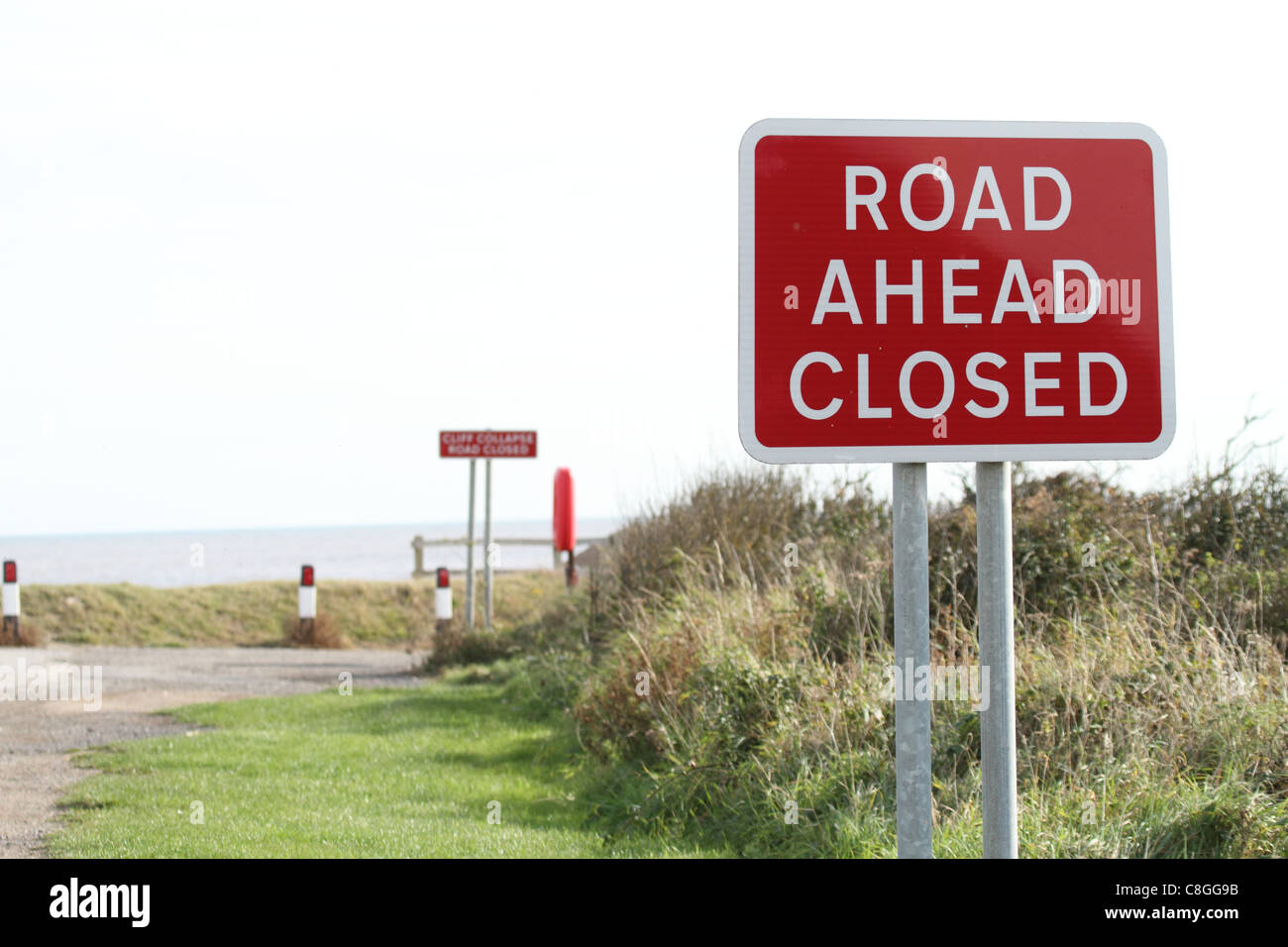 road ahead closed warning sign with cliff collapsed sign in background ...