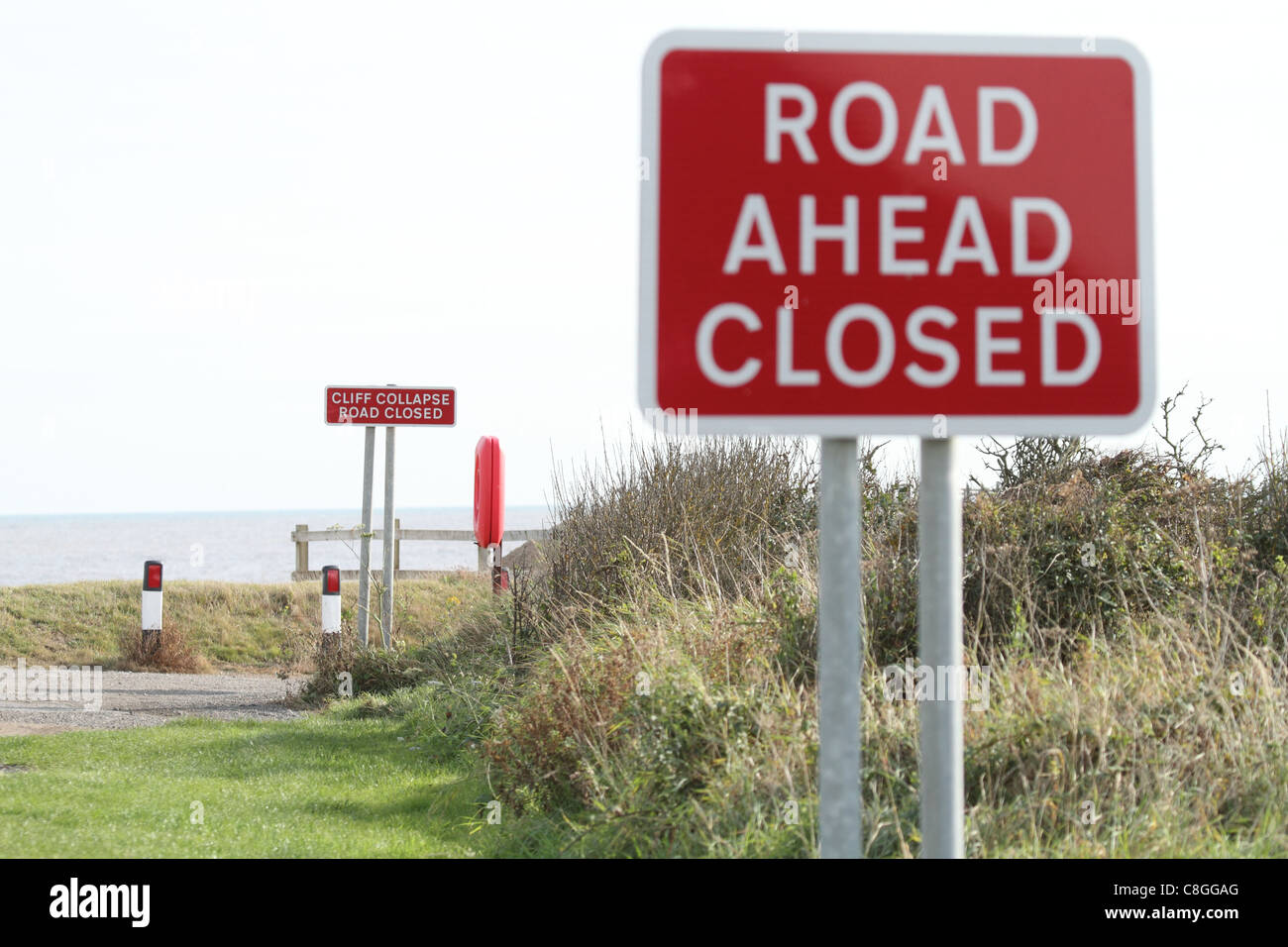 road ahead closed warning sign with cliff collapsed sign in background ...