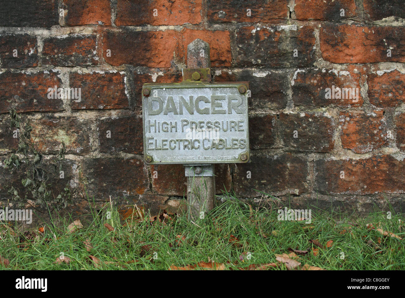 old warning sign danger high pressure electric cables Stock Photo - Alamy