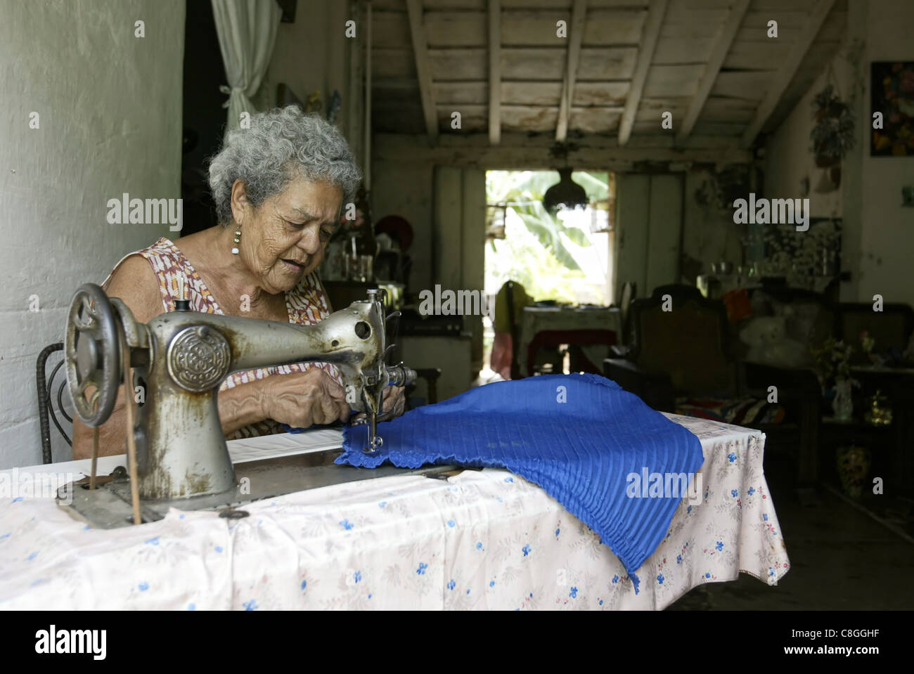 Cuban woman using sewing machine at home Stock Photo - Alamy