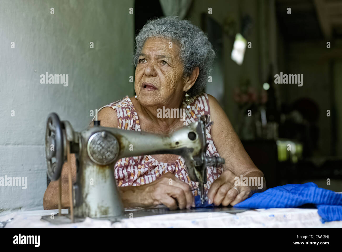 Cuban woman using sewing machine at home Stock Photo - Alamy